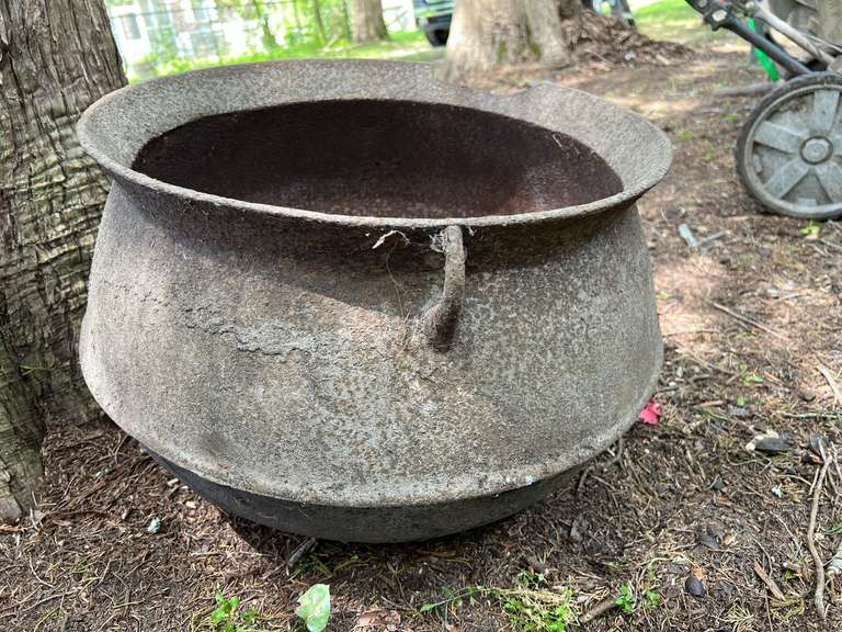 Barn… Large cast-iron cauldron, a piece of the rim has been broken off ...