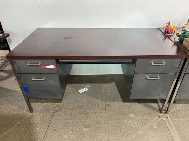 Five drawer metal office desk with wood look top, one of the drawers is ...