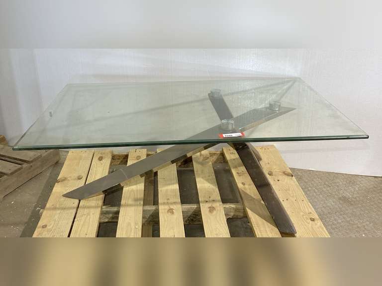 Contemporary glass coffee table with beveled edge, there are a couple ...