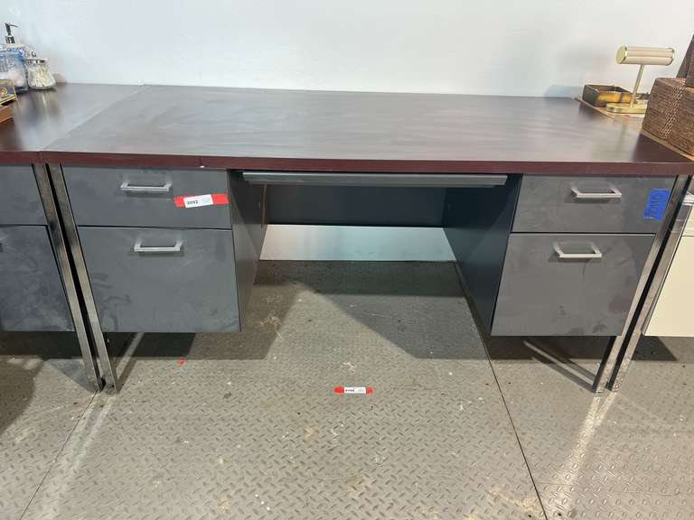Five drawer metal office desk with wood look top, one of the drawers is ...