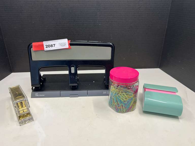 Assorted office items to include a hole punch, stapler, paper clips ...